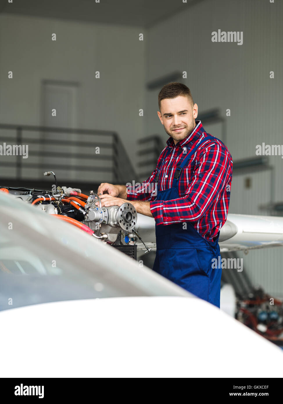 Handyman repairing aircraft in workshop Stock Photo - Alamy