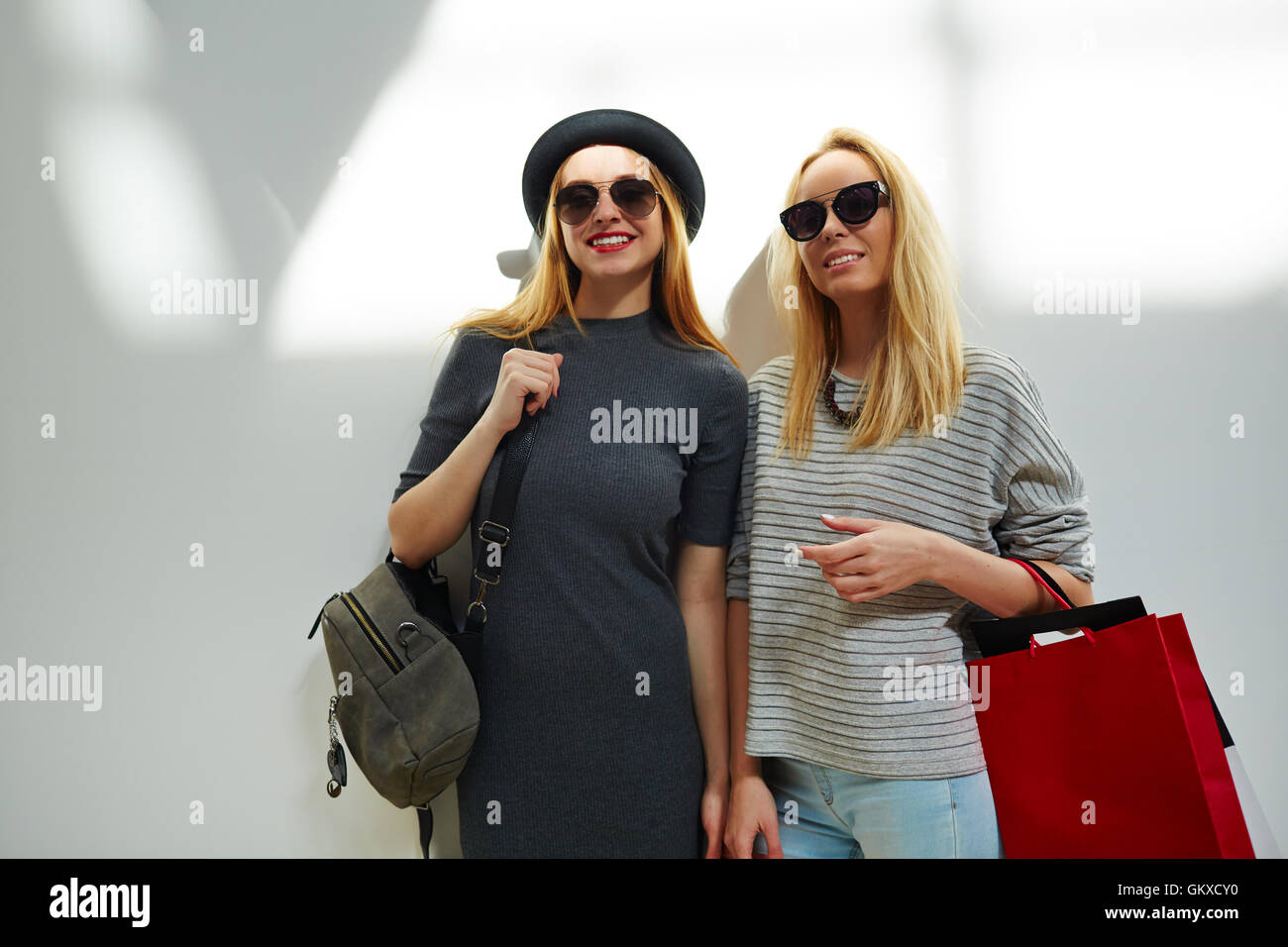 Stylish girls looking at camera with smiles Stock Photo - Alamy