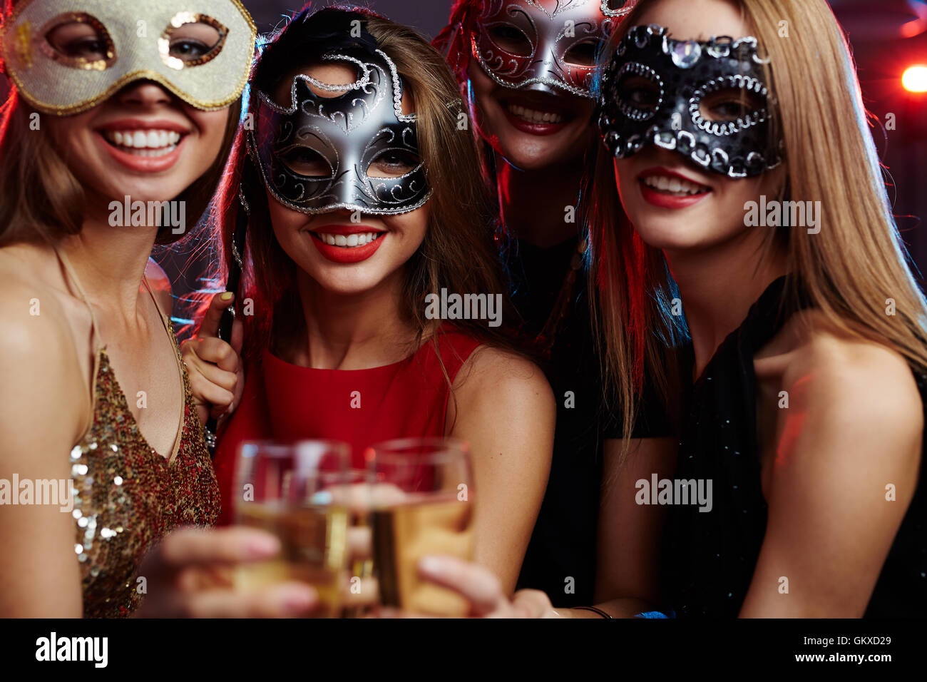 Young girls in masquerade masks toasting with champagne Stock Photo - Alamy