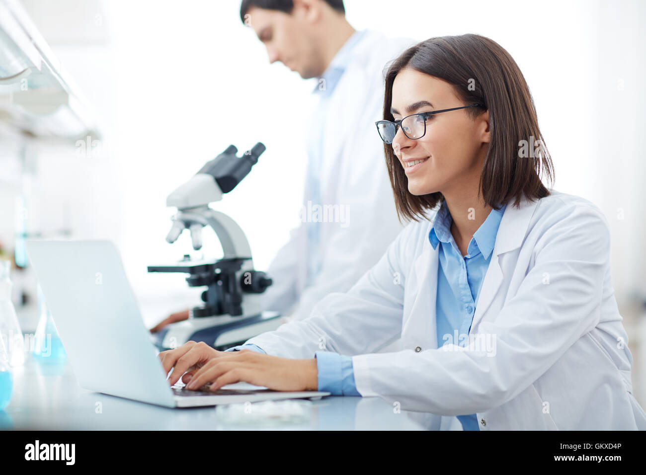 Young woman in uniform analyzing data in laboratory Stock Photo - Alamy