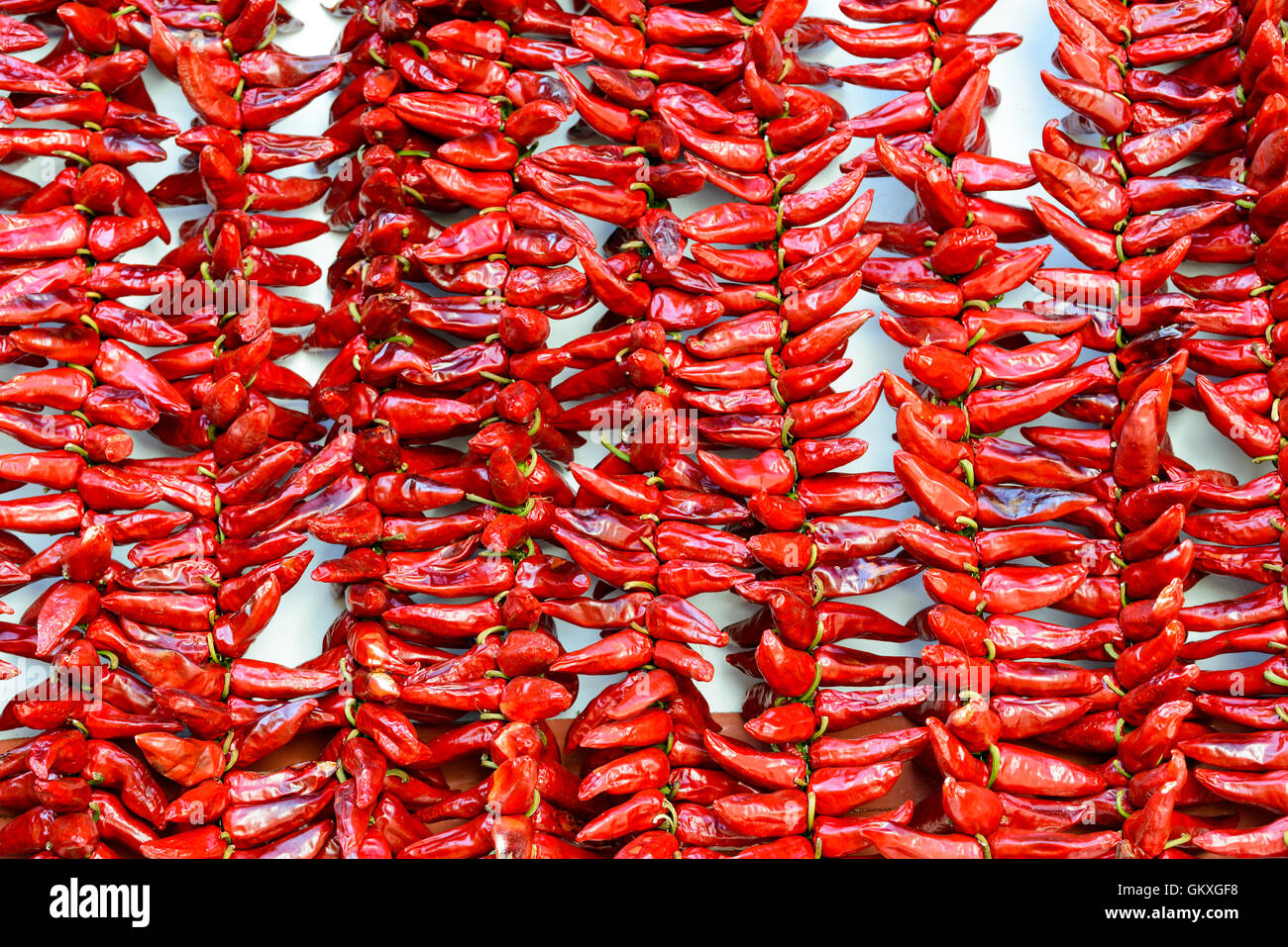 Strings of PDO Espelette chilli peppers drying, France Stock Photo - Alamy