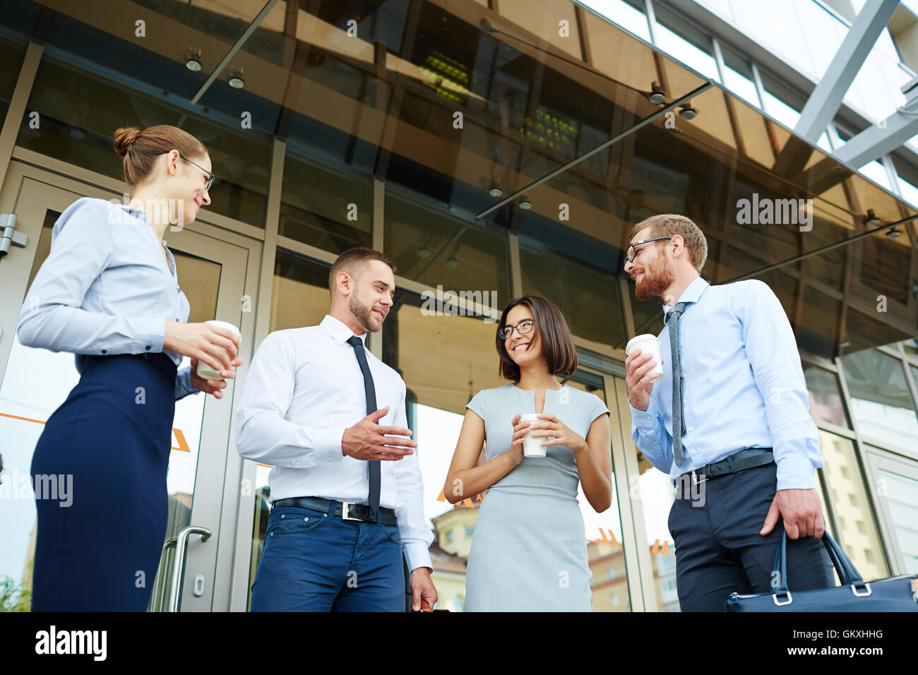 Group of elegant office workers communicating outdoors Stock Photo - Alamy