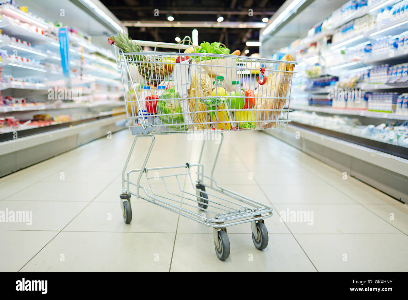 Consumer cart with products in supermarket Stock Photo - Alamy