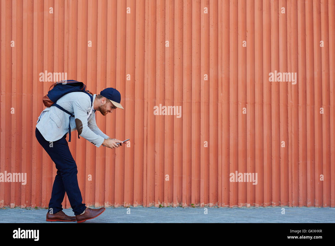Active young man playing popular outdoor mobile game Stock Photo - Alamy