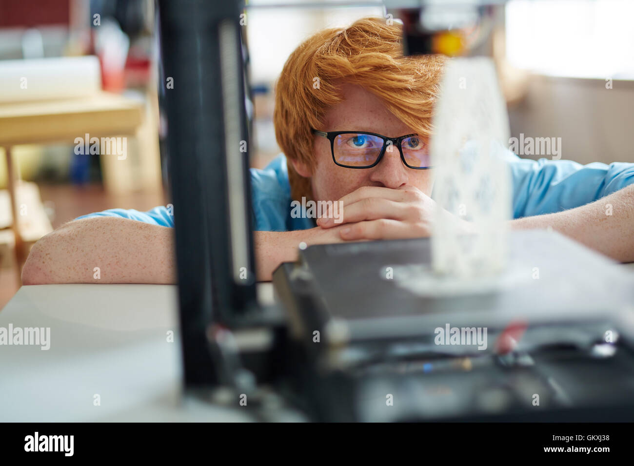 Serious designer looking at new architectural model in 3d printer Stock ...