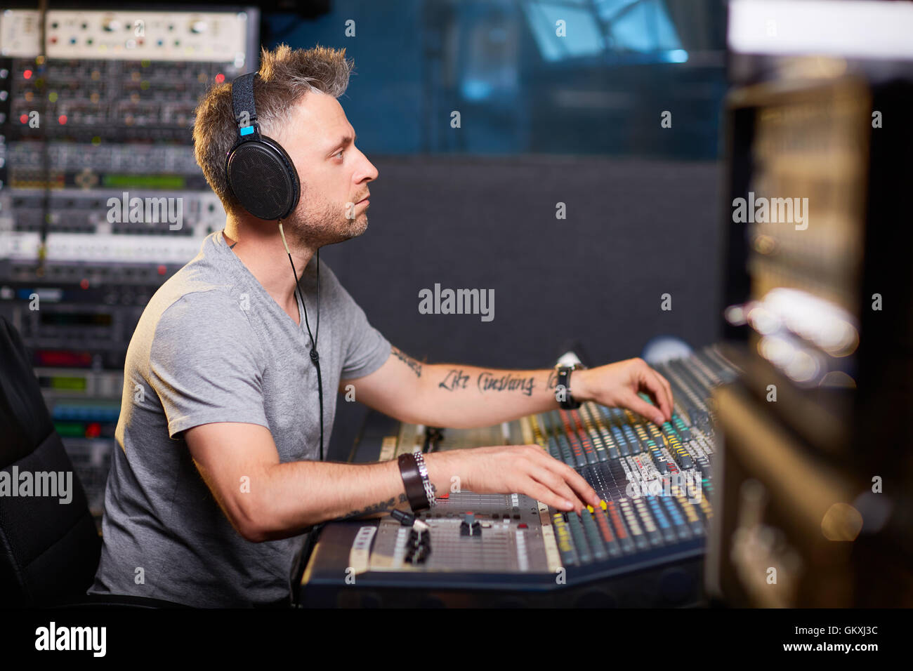 Serious deejay or music operator working in recording studio Stock ...