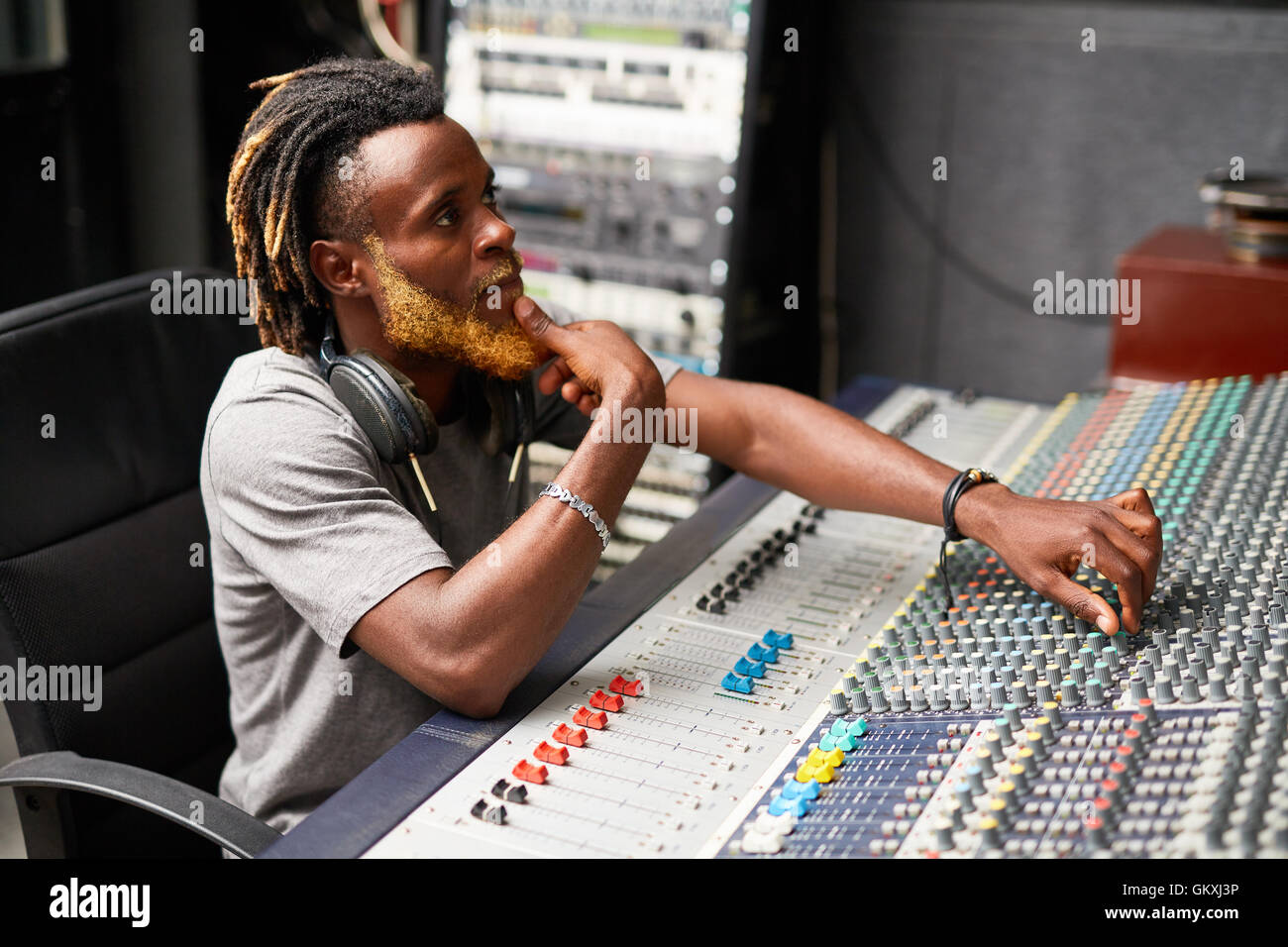 Handsome sound operator working in audio studio Stock Photo - Alamy