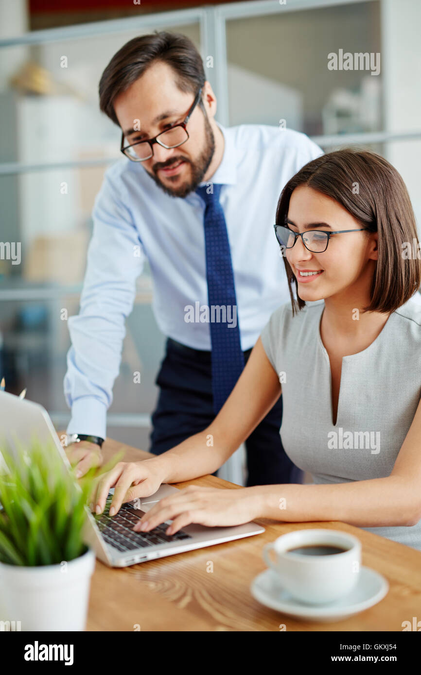Young secretary typing with her boss near by Stock Photo - Alamy
