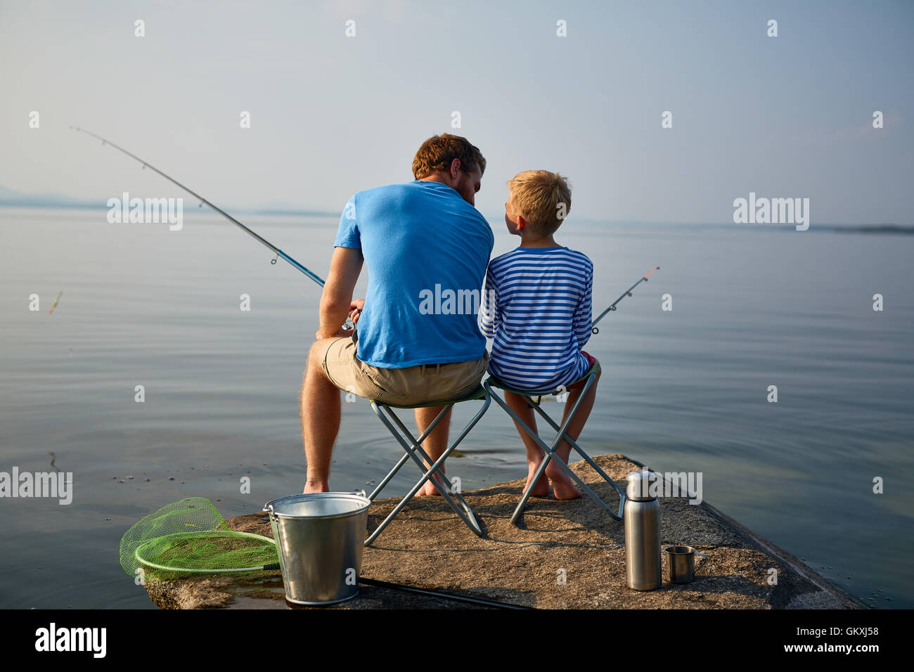 Man sitting on bucket fishing hi-res stock photography and images - Alamy