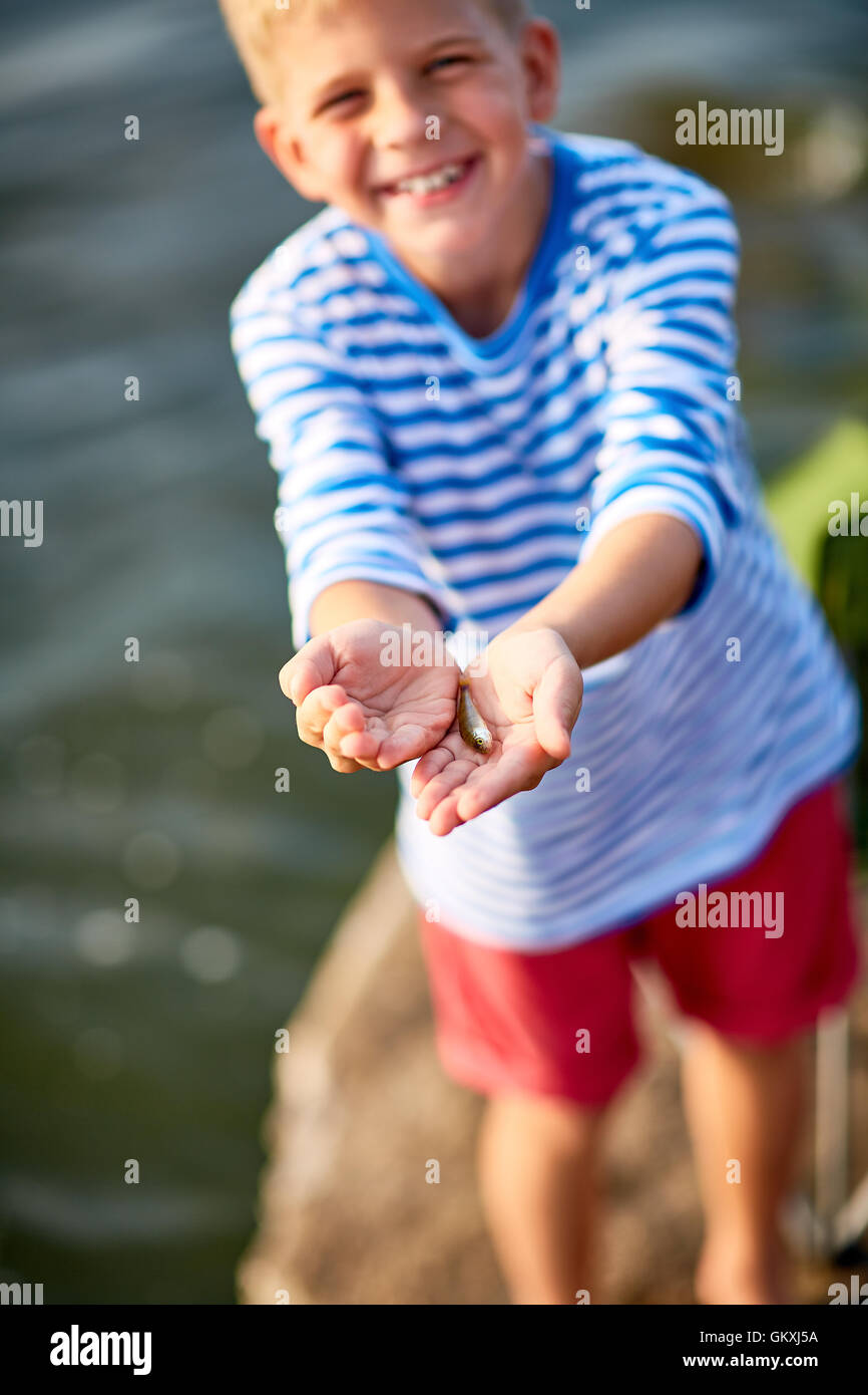 Boy fishing on small lake hi-res stock photography and images - Alamy