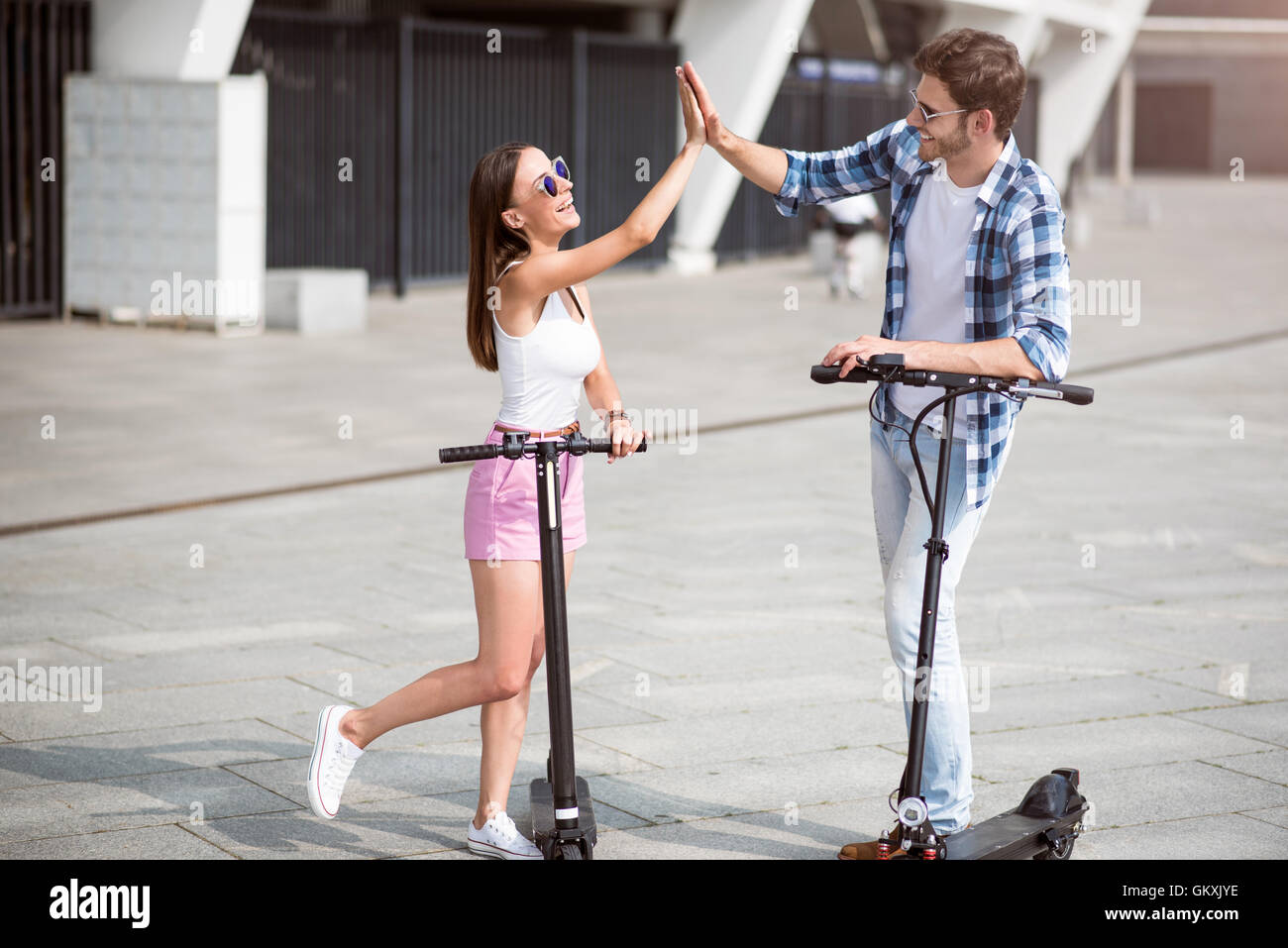 Positive friends giving high five Stock Photo - Alamy