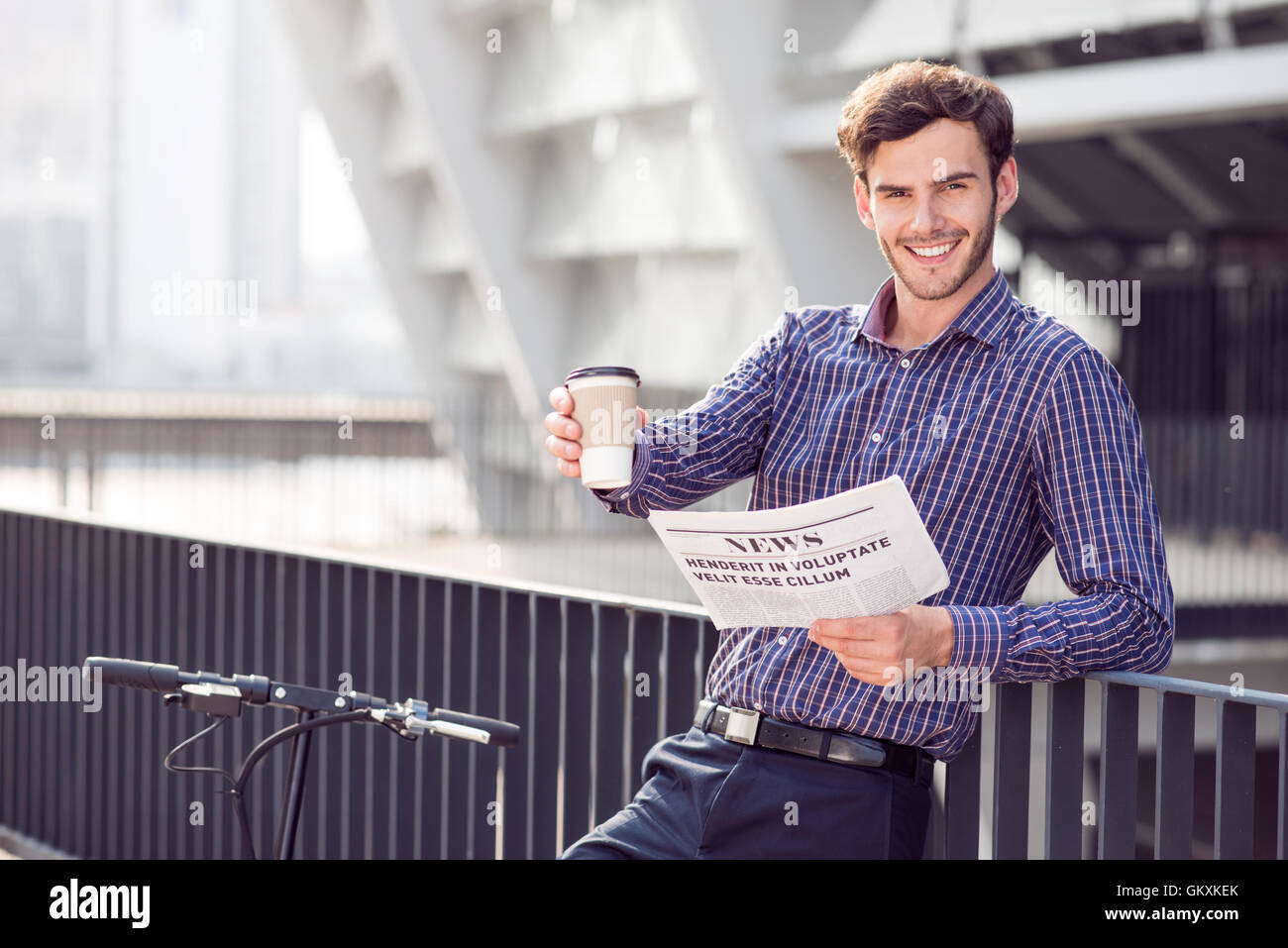 Positive man drinking coffee Stock Photo - Alamy