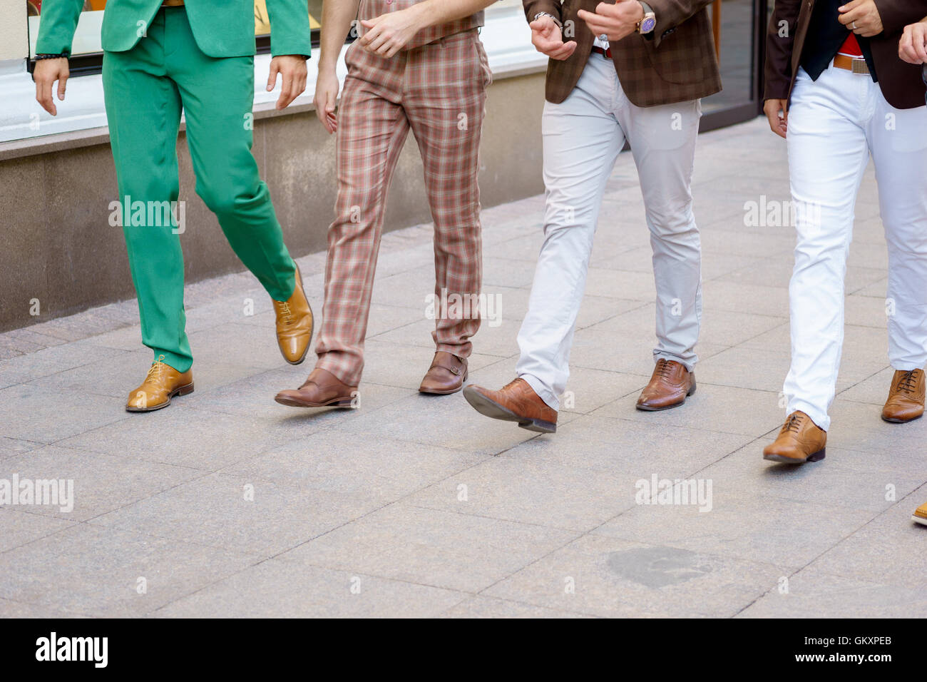 Group of stylish men walking down the street Stock Photo - Alamy