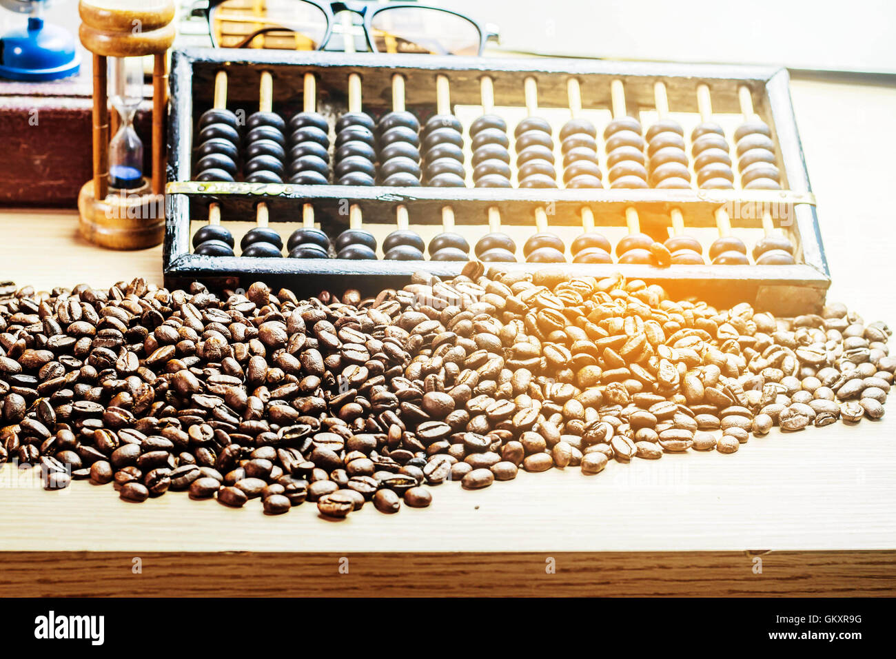 Coffee beans and abacus on a desk Stock Photo - Alamy