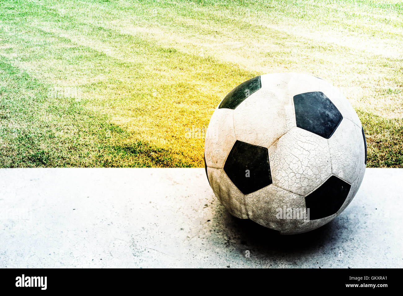 Football on concrete with the lawn Stock Photo - Alamy