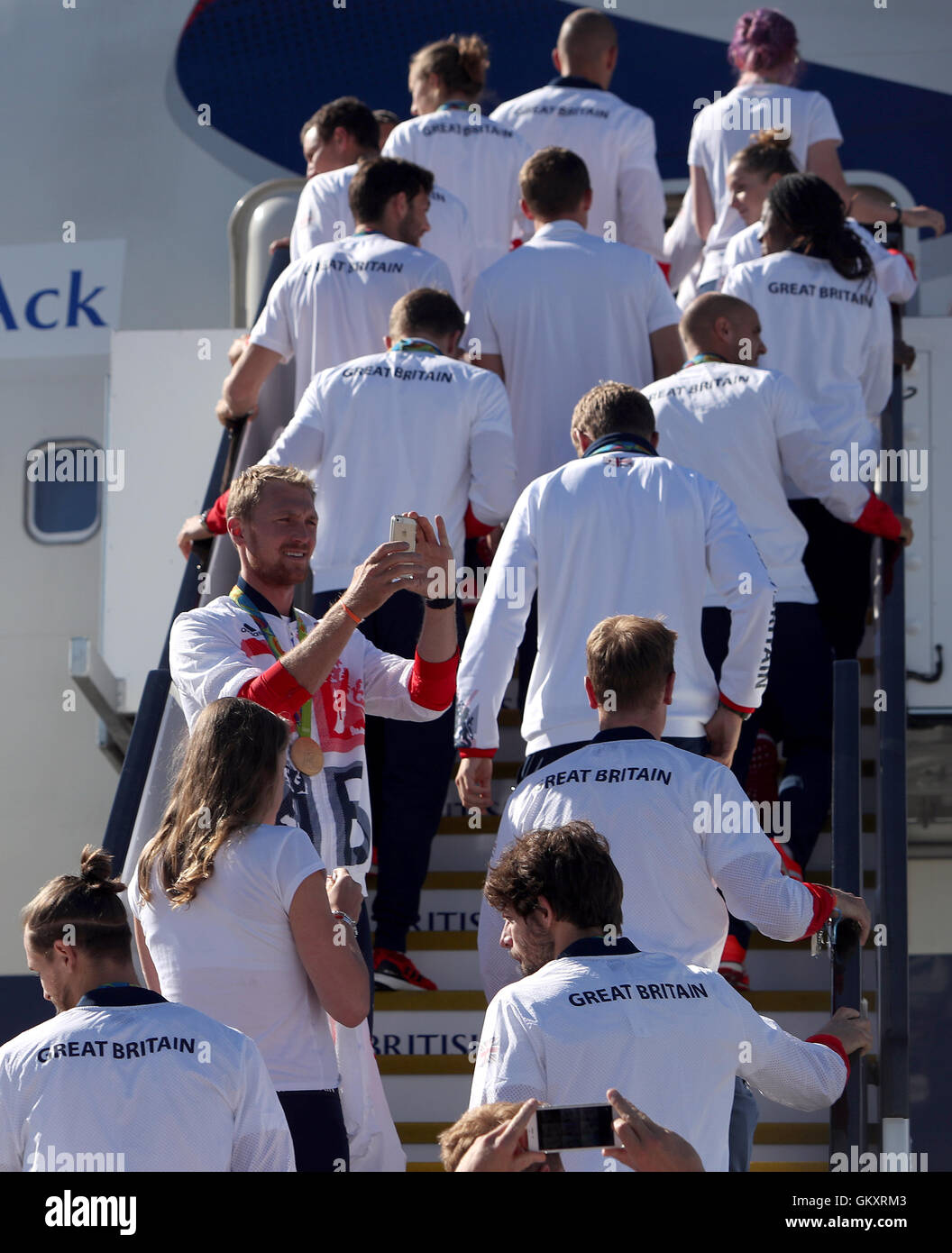 Great Britain's Alex Gregory takes a picture as he arrives at Heathrow ...