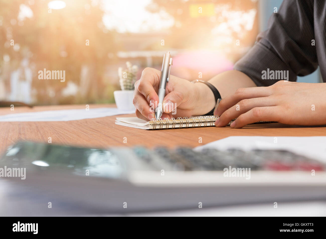 businessman writing note on notepad on office desk Stock Photo - Alamy