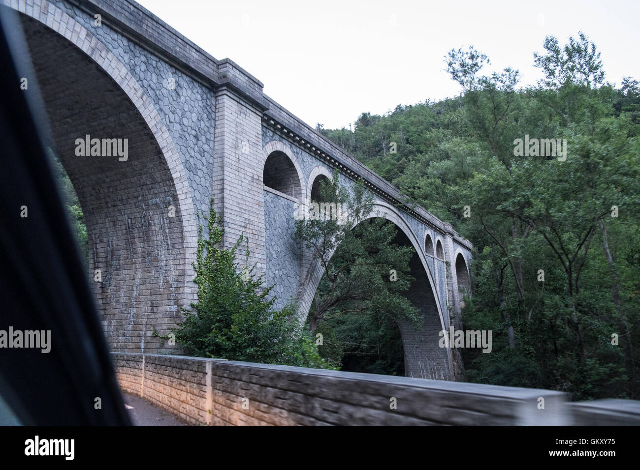 Train line arched bridge over River Aude along D117 road on Gorges de ...