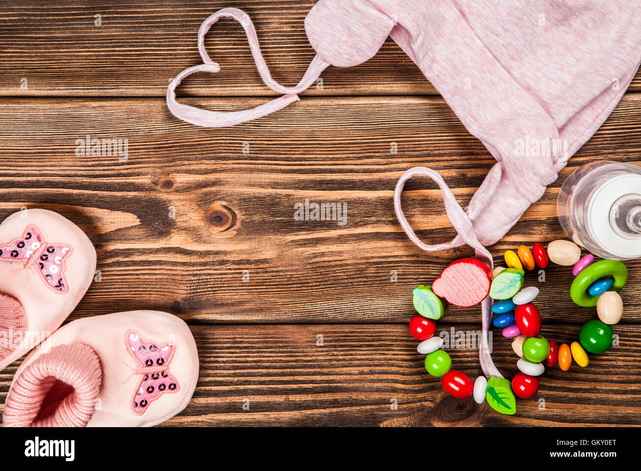 Baby clothes on wooden background Stock Photo - Alamy