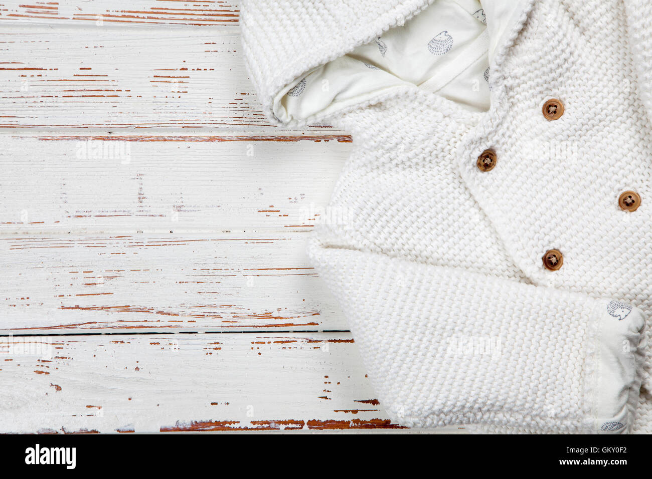 Baby clothes on wooden background Stock Photo - Alamy