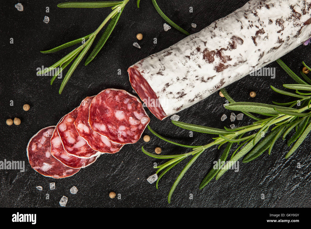 Salami on dark background Stock Photo - Alamy