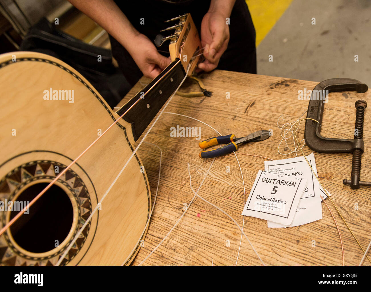 Los Angeles, California, USA. 23rd Aug, 2016. CARLOS TORRES re-strings ...