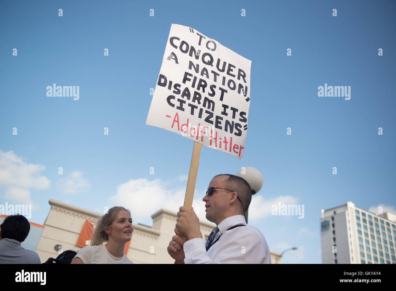 Open carry advocate ANDREW CLEMENTS holds Adolf Hitler banner as he ...