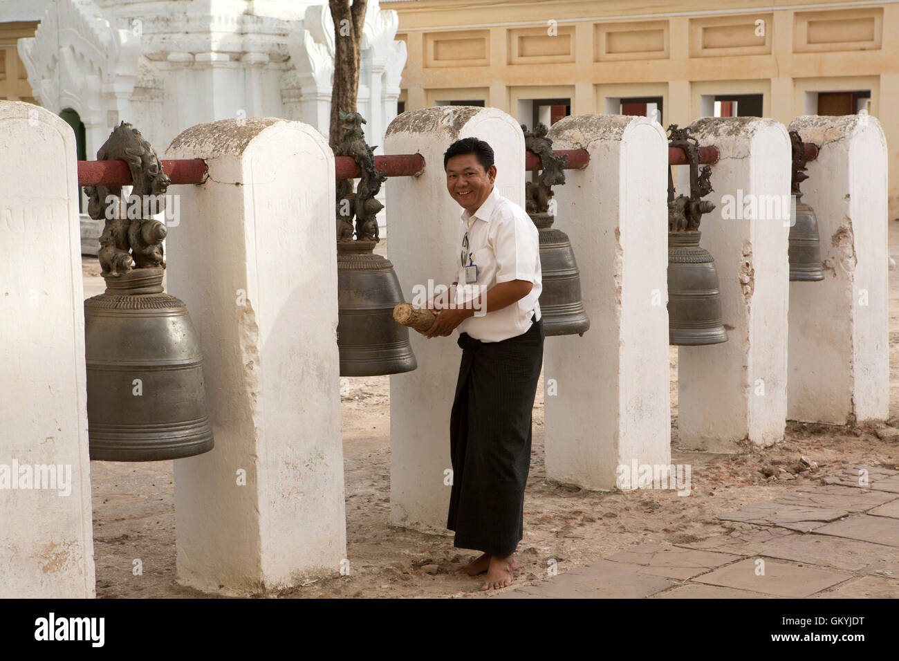 A Burmeserings a bell at a temple in Bagan, Myanmar (Burma). He uses a ...