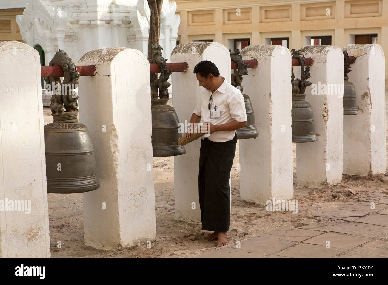 A Burmeserings a bell at a temple in Bagan, Myanmar (Burma). He uses a ...