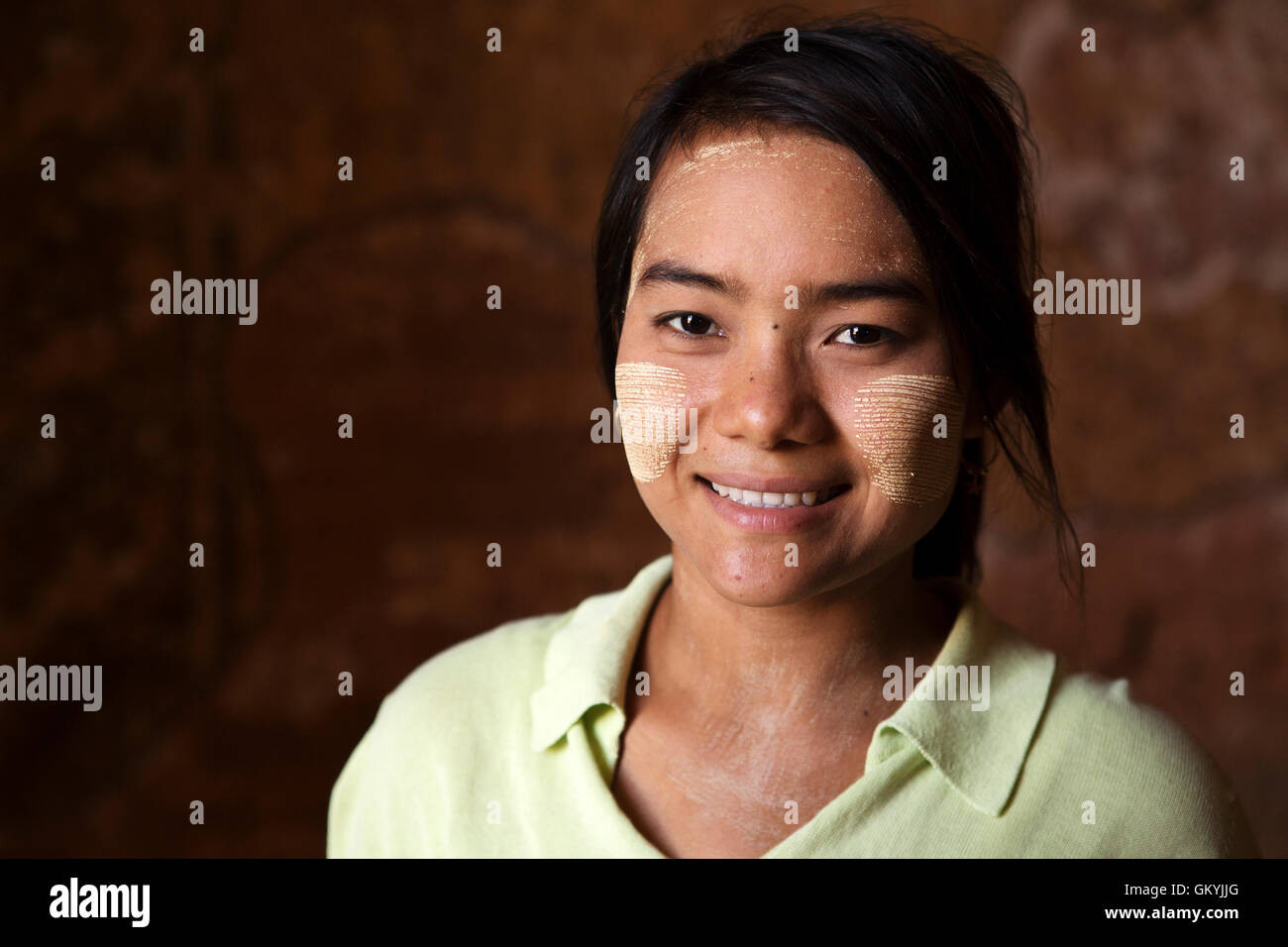 A Burmese woman at a temple in Bagan, Myanmar (Burma). She wears ...