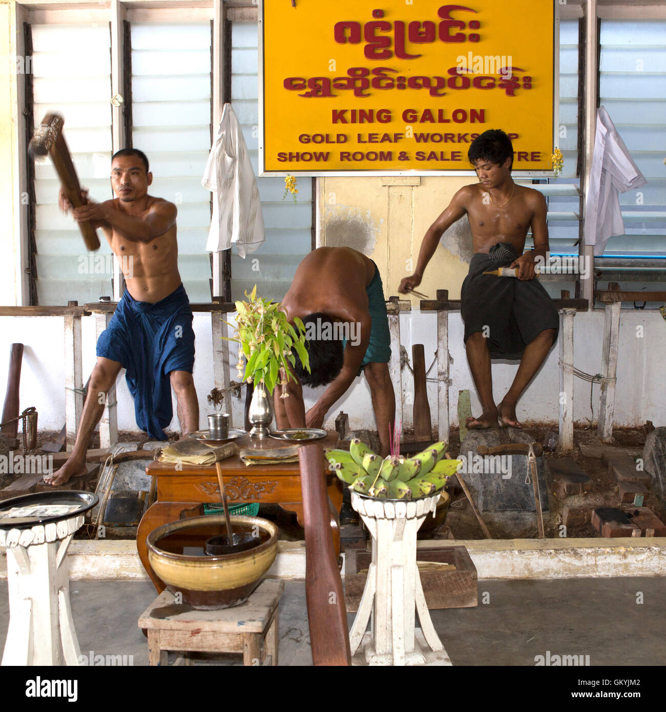 Burmese men beat gold at the King Galon Workshop in Mandalay, Myanmar ...