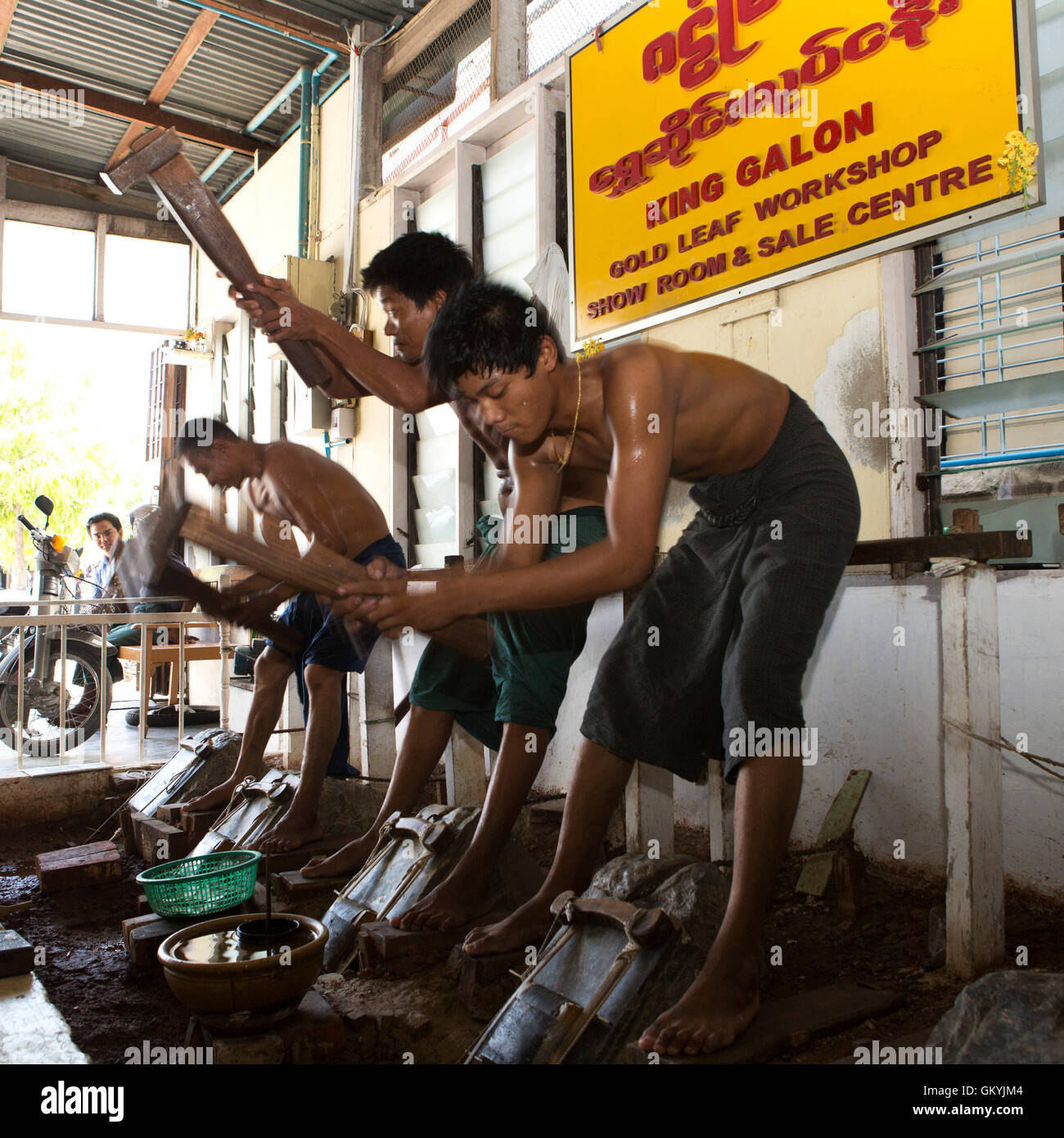 A team of Burmese men beat gold at the King Galon Workshop in Mandalay ...