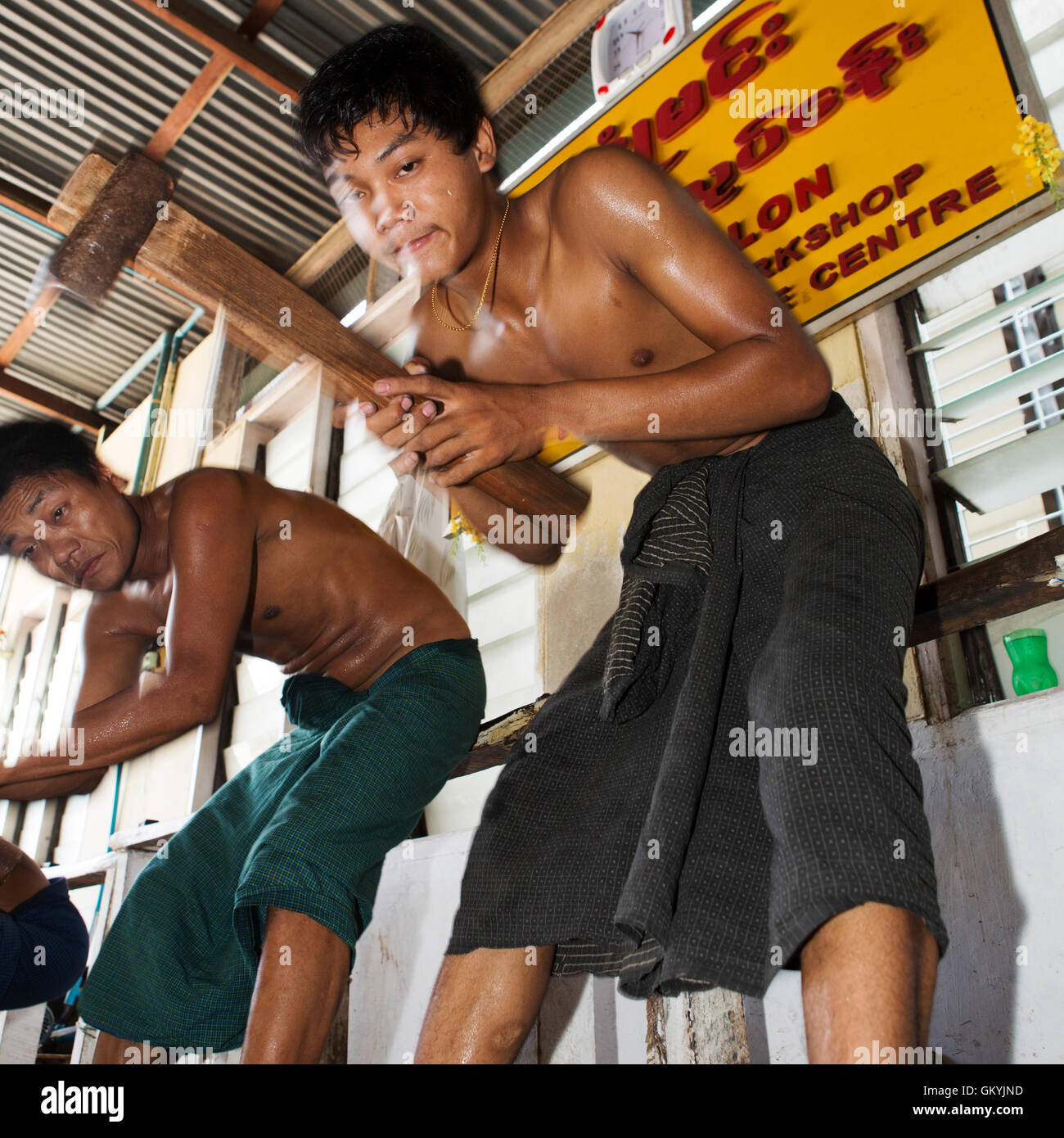 A team of Burmese men beat gold at the King Galon Workshop in Mandalay, Myanmar (Burma). They ...