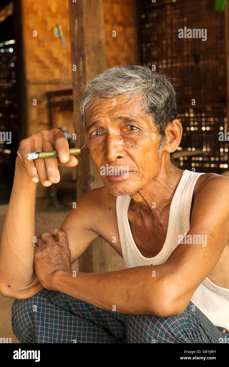 A Burmese man smoking at his house in Minnathu Village near Bagan ...
