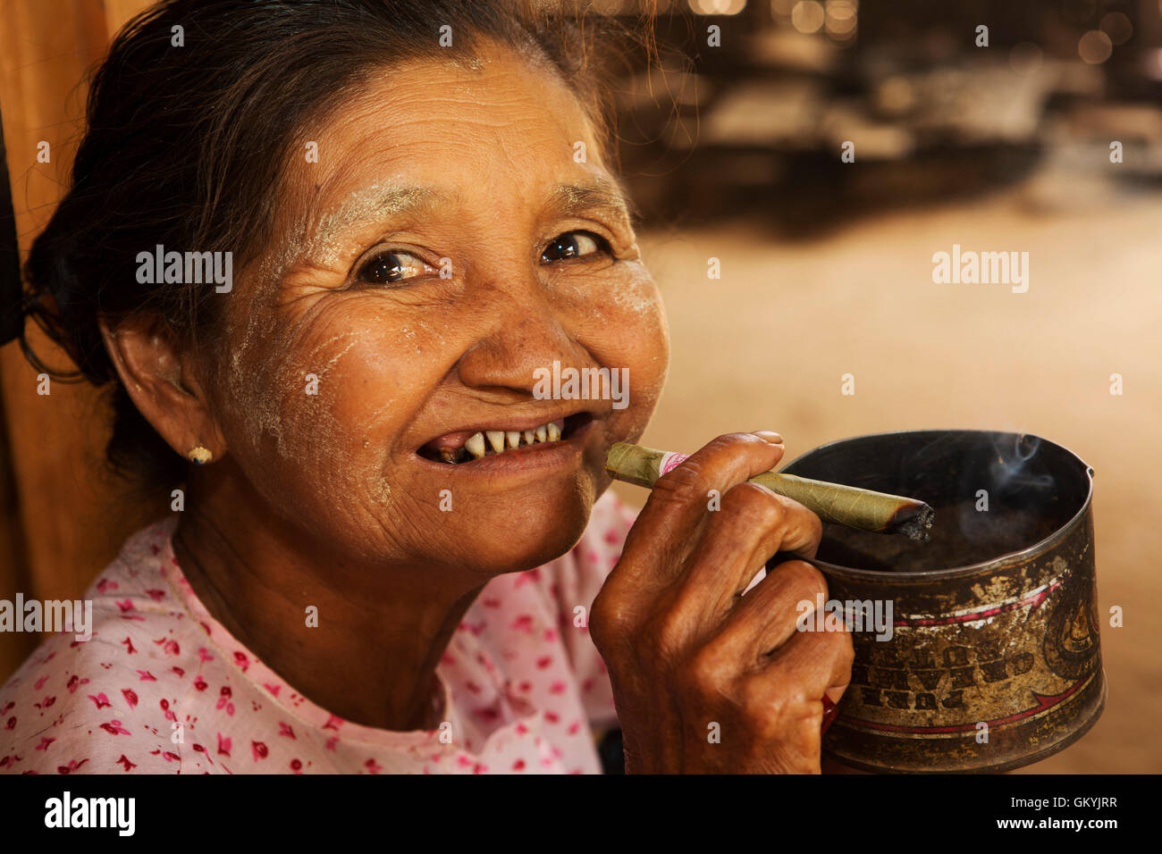 A Burmese woman smoking at her house in Minnathu Village near Bagan ...