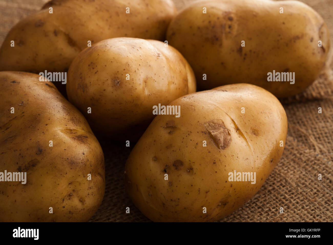 potato ingredient raw rustic still life sack background Stock Photo - Alamy