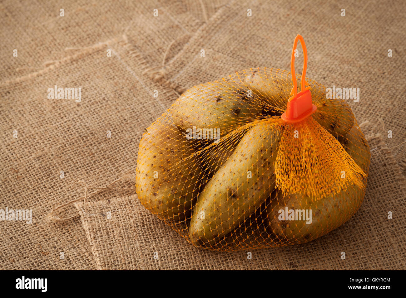 potato ingredient raw rustic still life sack background Stock Photo - Alamy