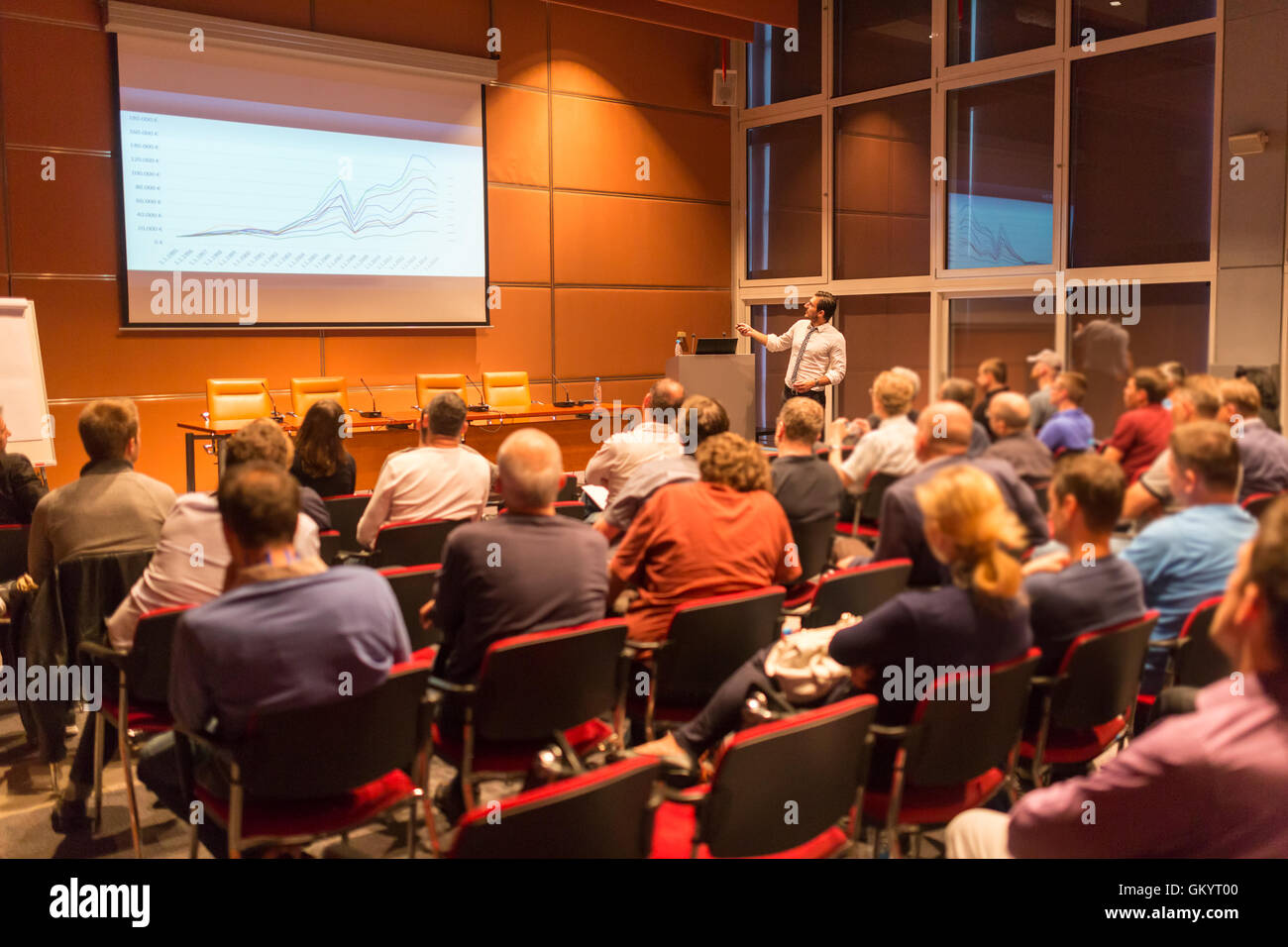 Business speaker giving a talk in conference hall Stock Photo - Alamy