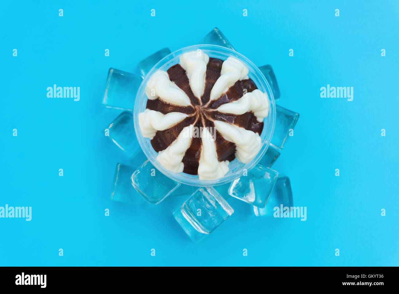 top view cup of chocolate flavor ice cream and ice cube on blue ...