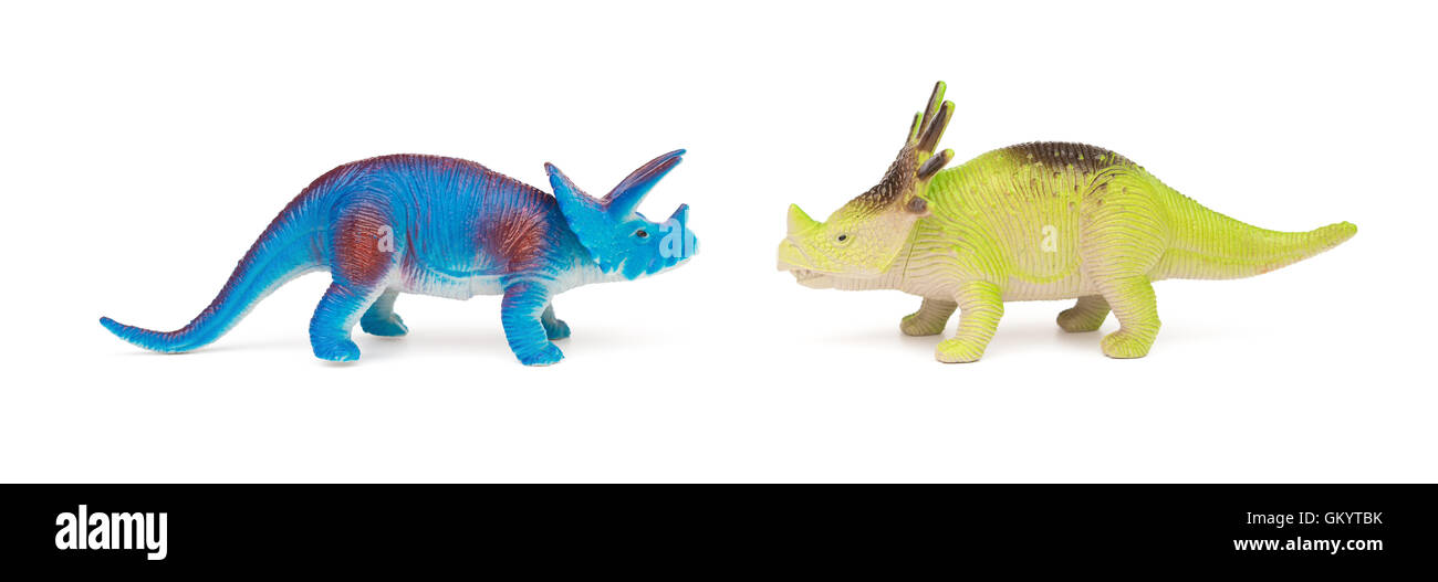 blue triceratops and green styracosaurus toys on a white background ...