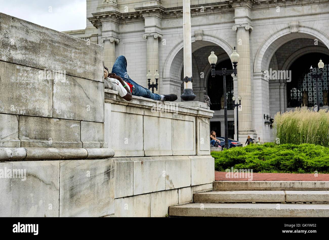Homeless man sleeping on a marble wall at Union Station Washington DC ...