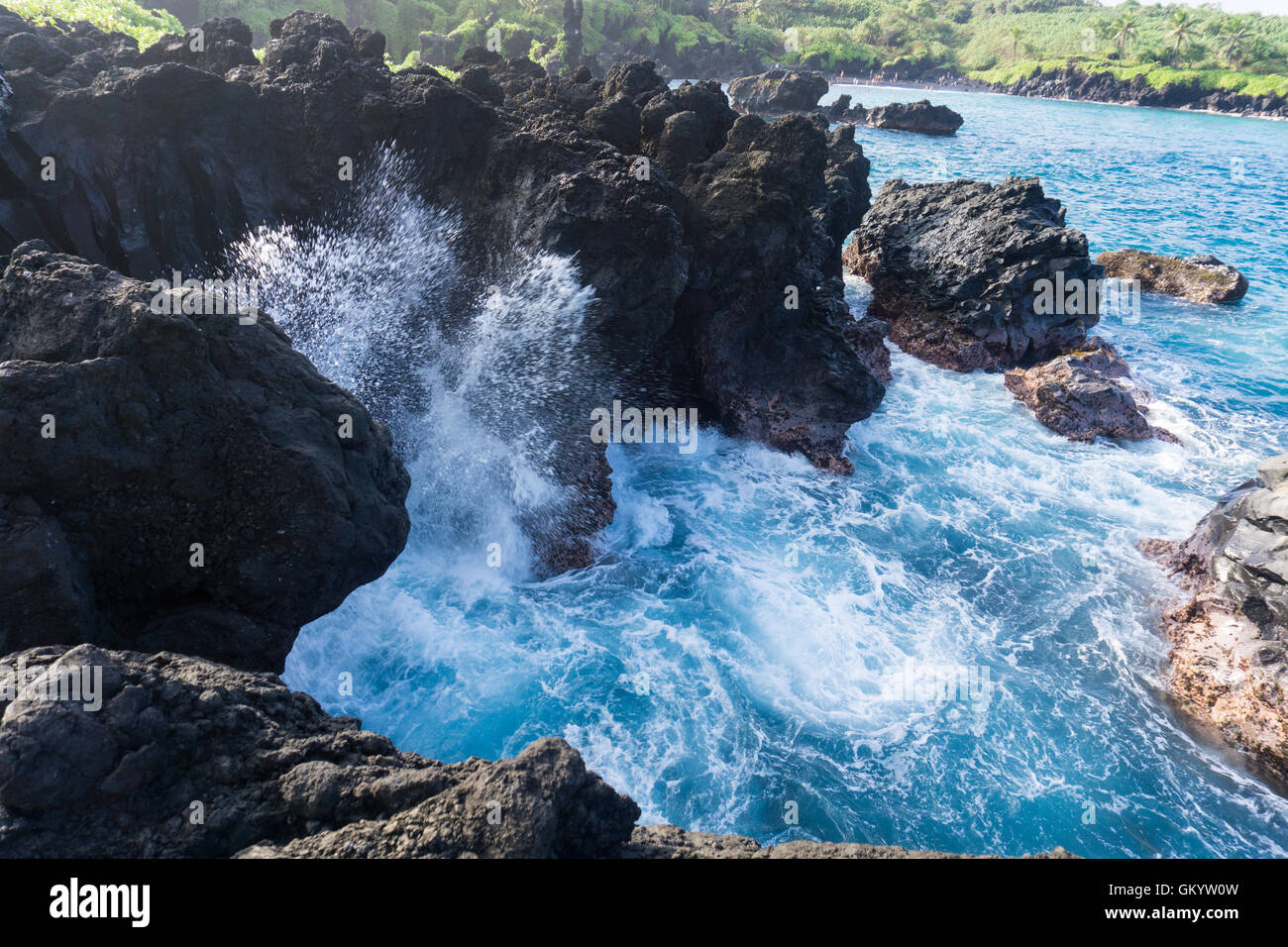 Ocean wave breaking against rocks in Hawaii Stock Photo - Alamy