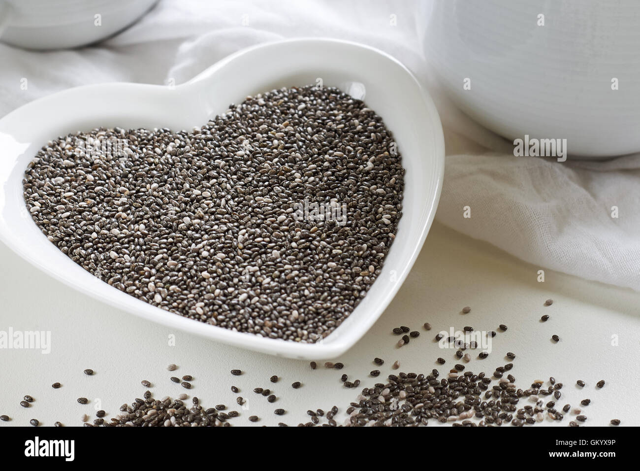 Chia seeds in heart shaped ceramic bowl on white background Stock Photo ...