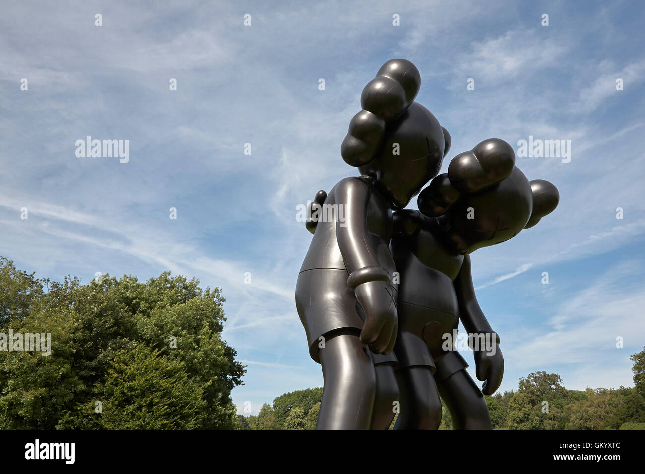 Kaws Along the Way black wooden sculpture in the Yorkshire Sculpture ...