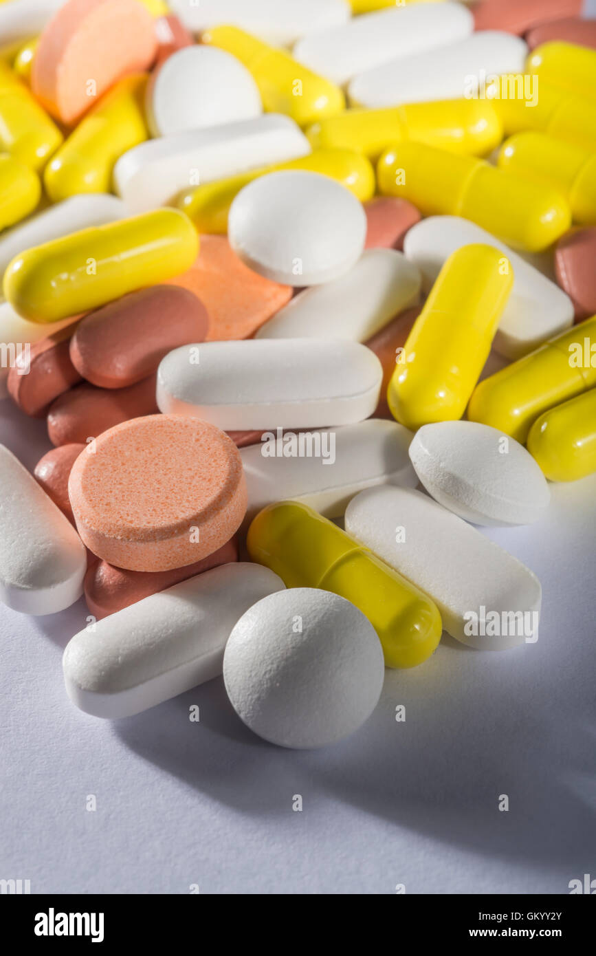 Stack of different colorful pills Stock Photo - Alamy