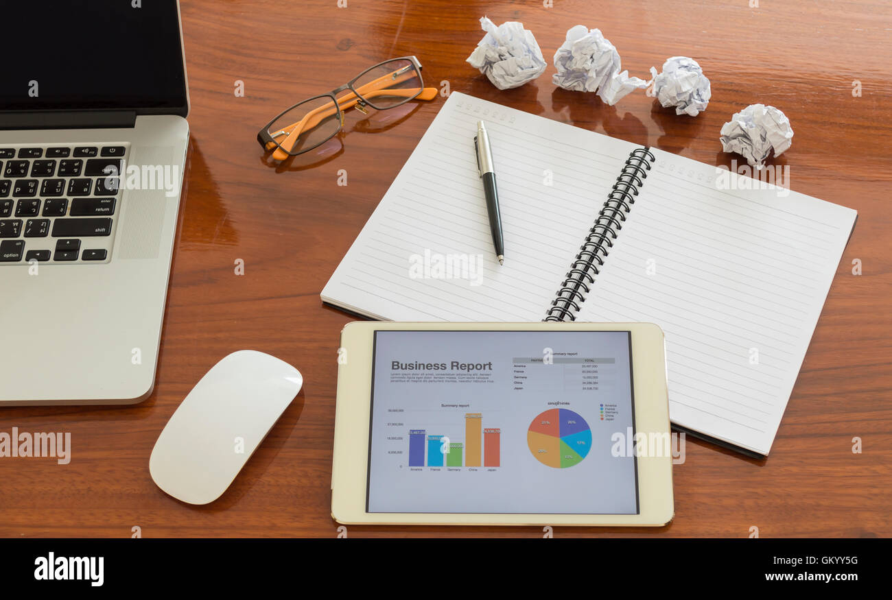 desk work Office wood table with notepad, computer and flower.On top ...