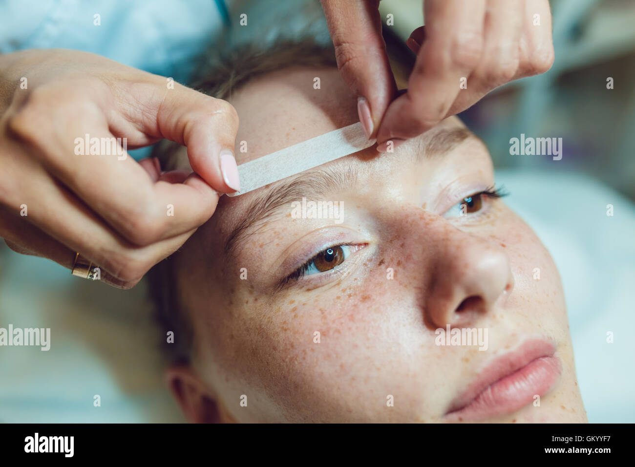 Beautiful young woman getting a face treatment at beauty salon ...