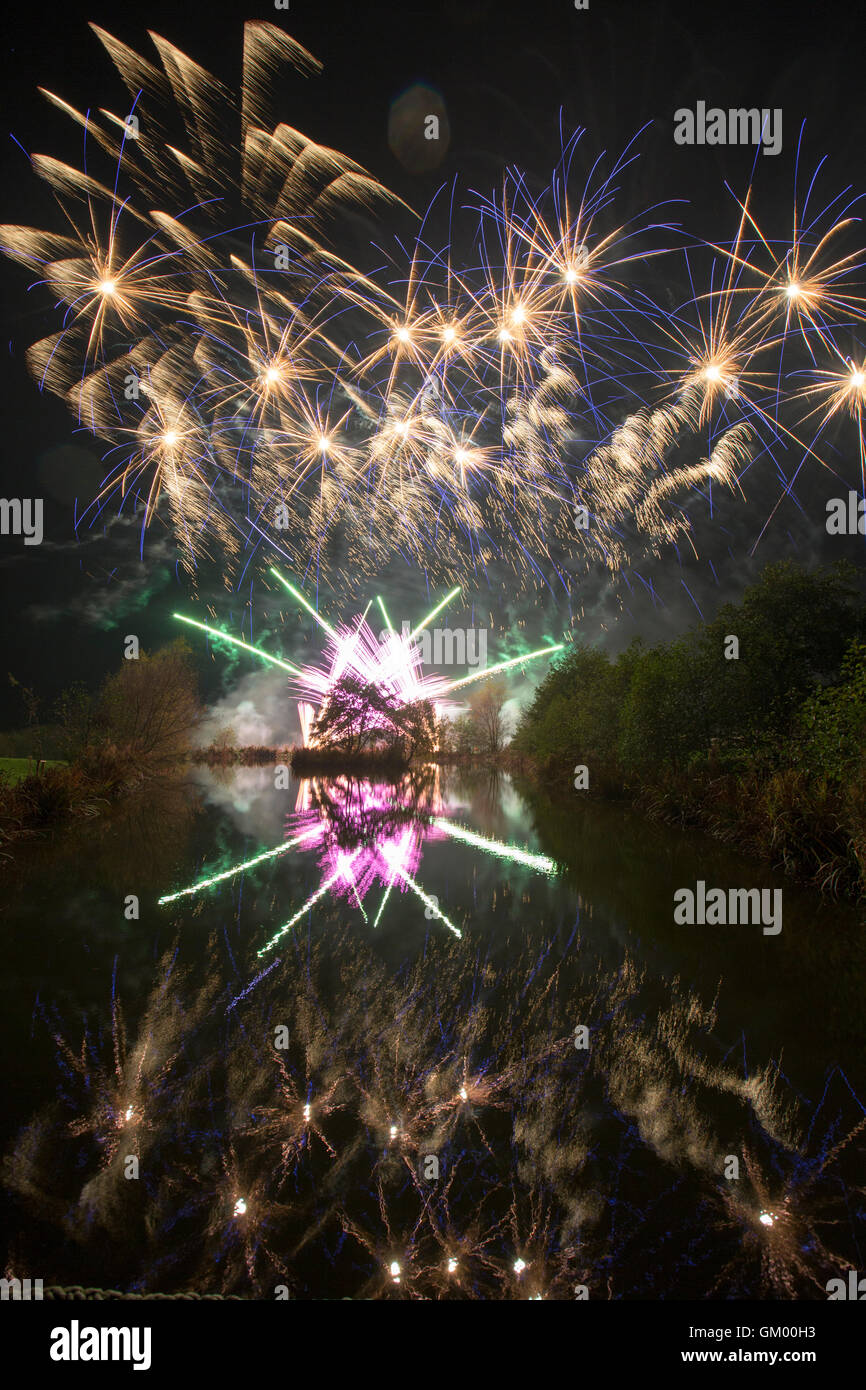 Spectacular and colourful firework display set against a dark Autumn ...