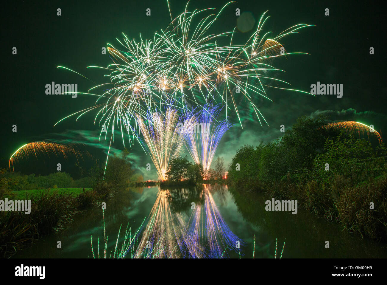 Spectacular and colourful firework display set against a dark Autumn ...