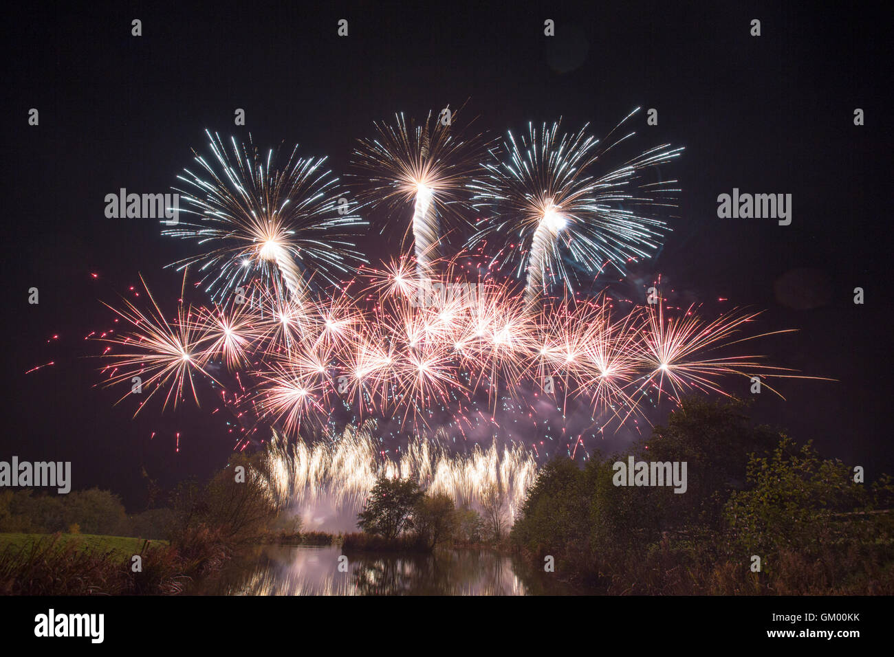 Spectacular and colourful firework display set against a dark Autumn ...
